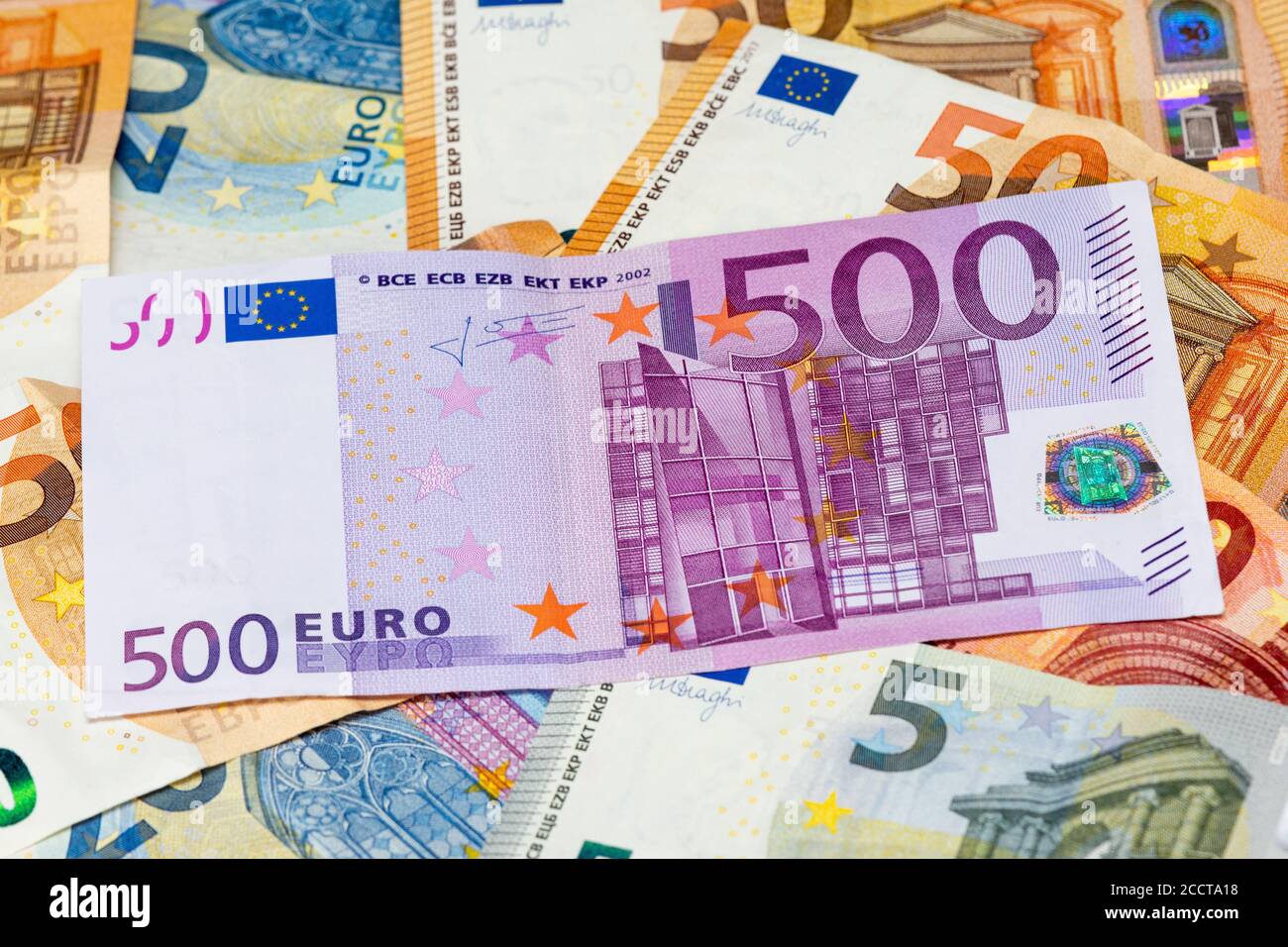500 euro bank note among 50, 20,10 and 5 euro bank notes. Close-up view ...