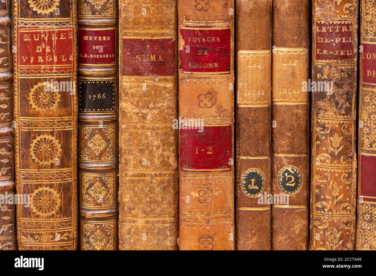 Row of ancient books with typical 18th century leather bindings. French ...