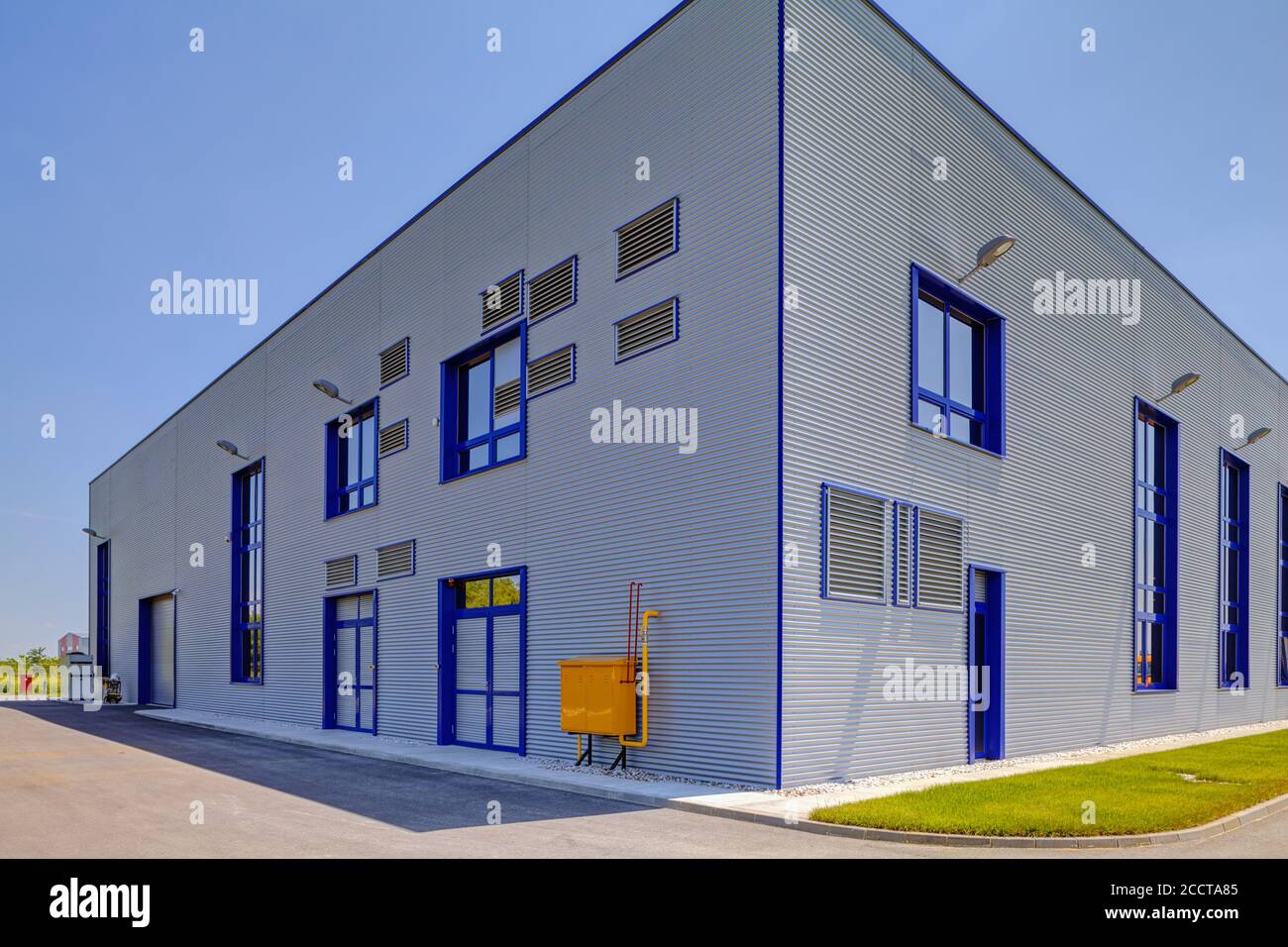 industrial building with blue windows Stock Photo - Alamy