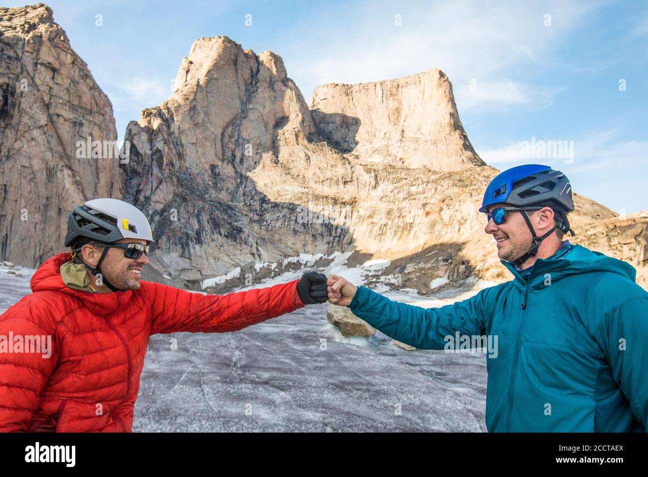 Two climber fist bump after a successful climb Stock Photo - Alamy