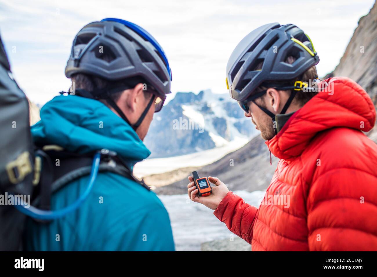 Two climbers use a GPS to navigate mountain terrain Stock Photo - Alamy