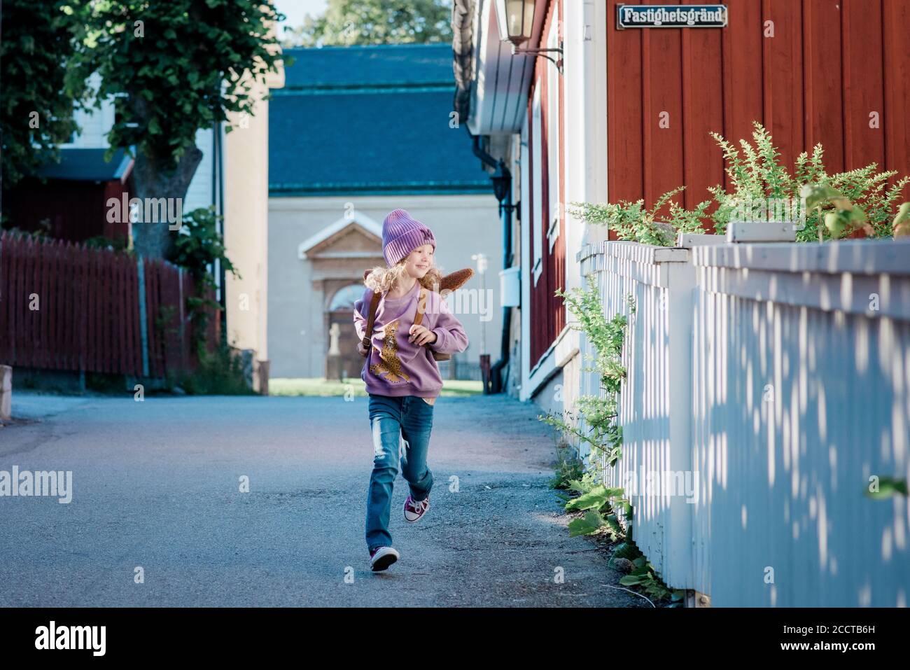 Girl running into school hi-res stock photography and images - Alamy