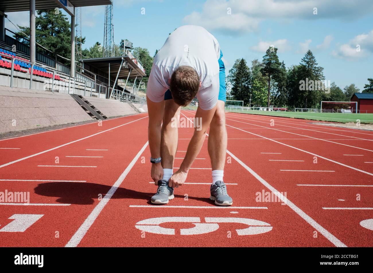 man getting ready to race on a race track Stock Photo - Alamy