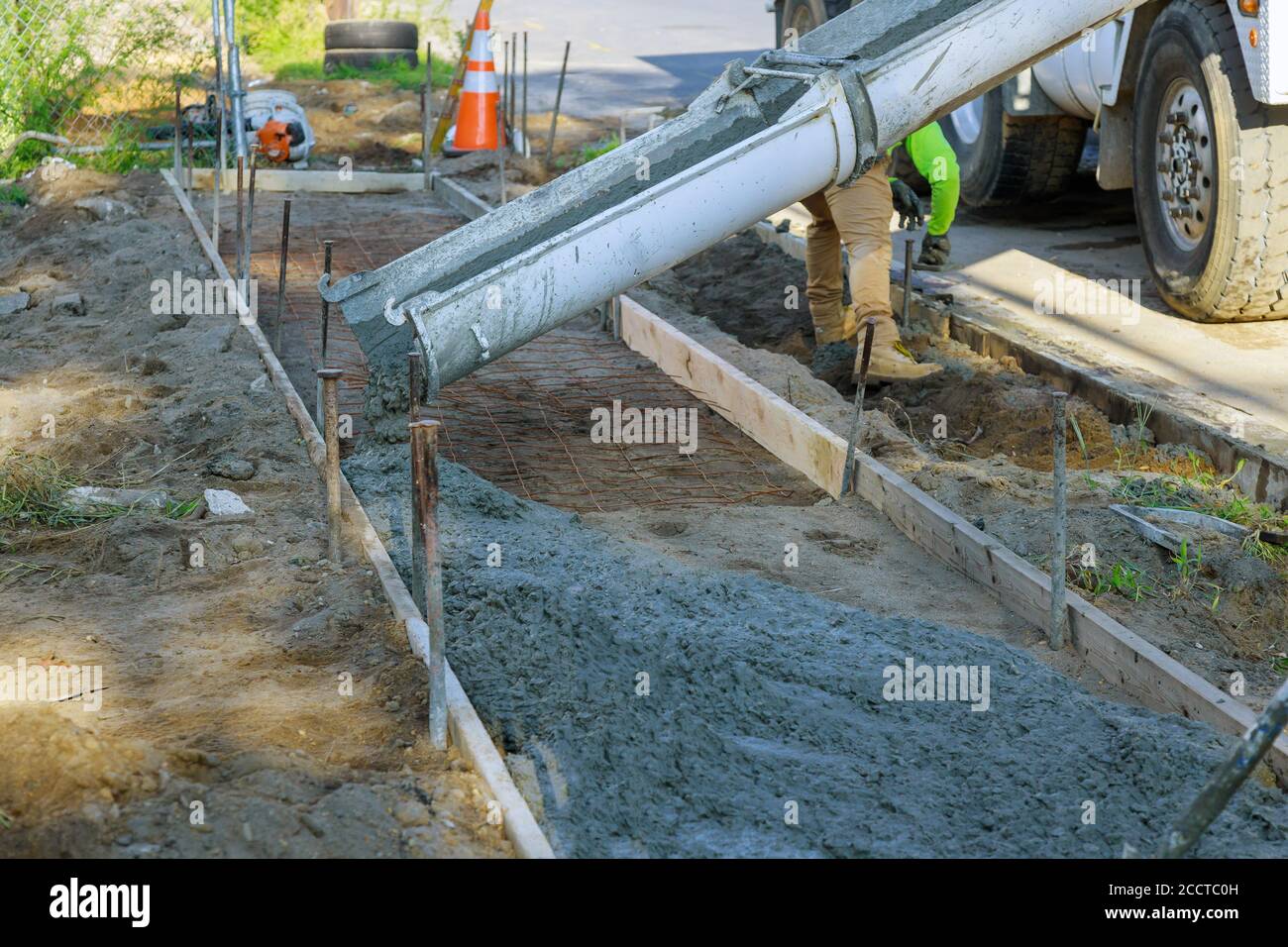 Construction mason building a screed coat cement a laborer floats a new ...