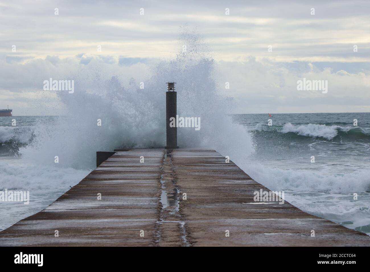 big ocean wave hit in a jetty in a stormy day Stock Photo - Alamy