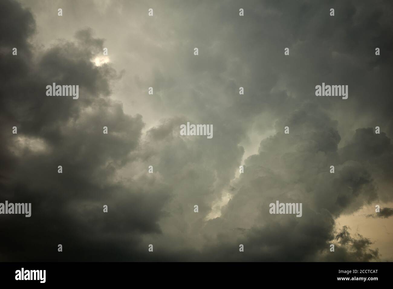 Cloudy sky with gray and yellow fluffy cumulous clouds. It is overcast ...