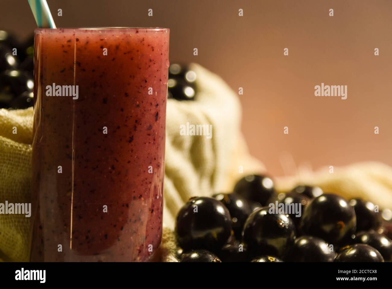 Fresh fruit and glass of jaboticaba juice. Jabuticaba is a fruit ...