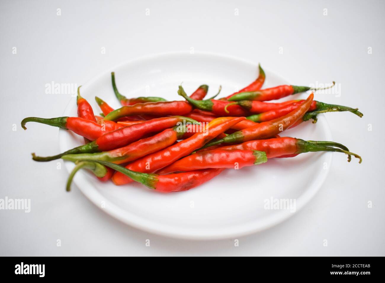 Fresh green chillies turned in to red ripe red chilly with green stem ...