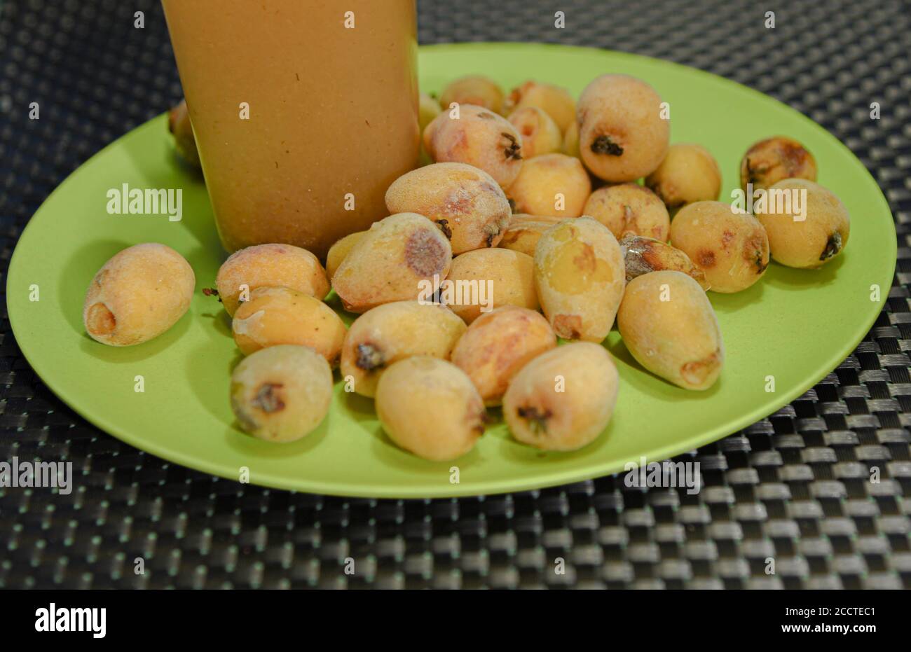 Frozen fruits and loquat juice. The loquat (Eriobotrya japonica) is a ...