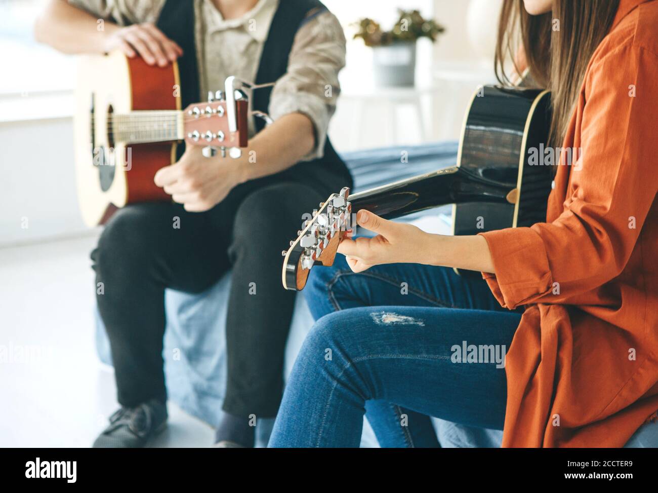 Learning to play the guitar. The teacher explains to the student the ...