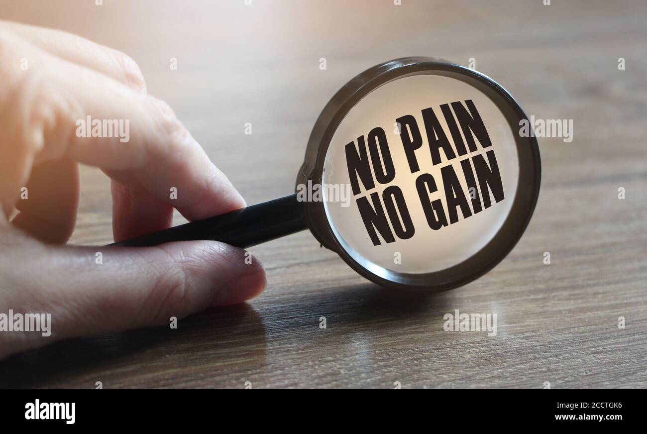 No Pain No Gain text concept with magnifying glass Stock Photo - Alamy
