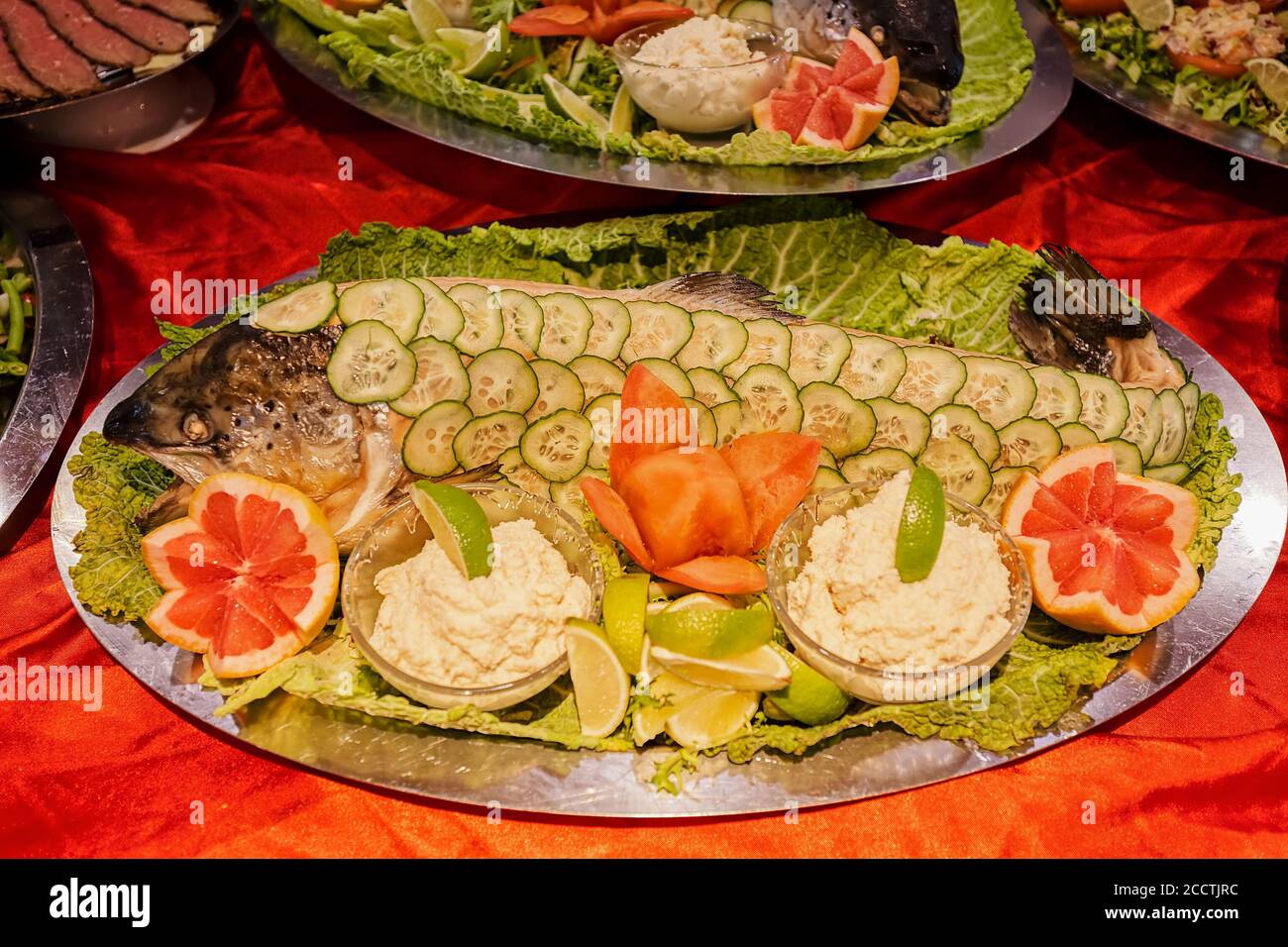 served whole fish with the help of vegetables Stock Photo - Alamy