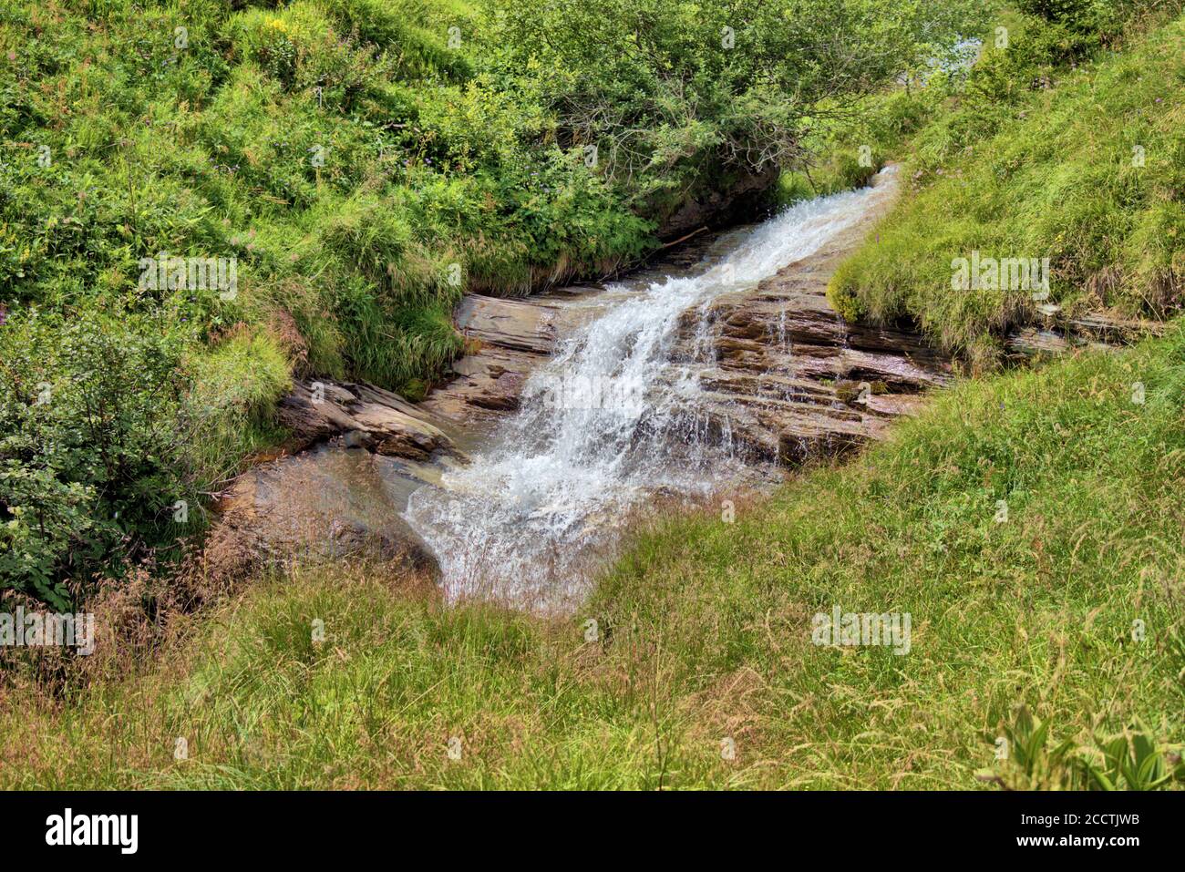 Alpine little waterfall in Vals in Switzerland Stock Photo - Alamy