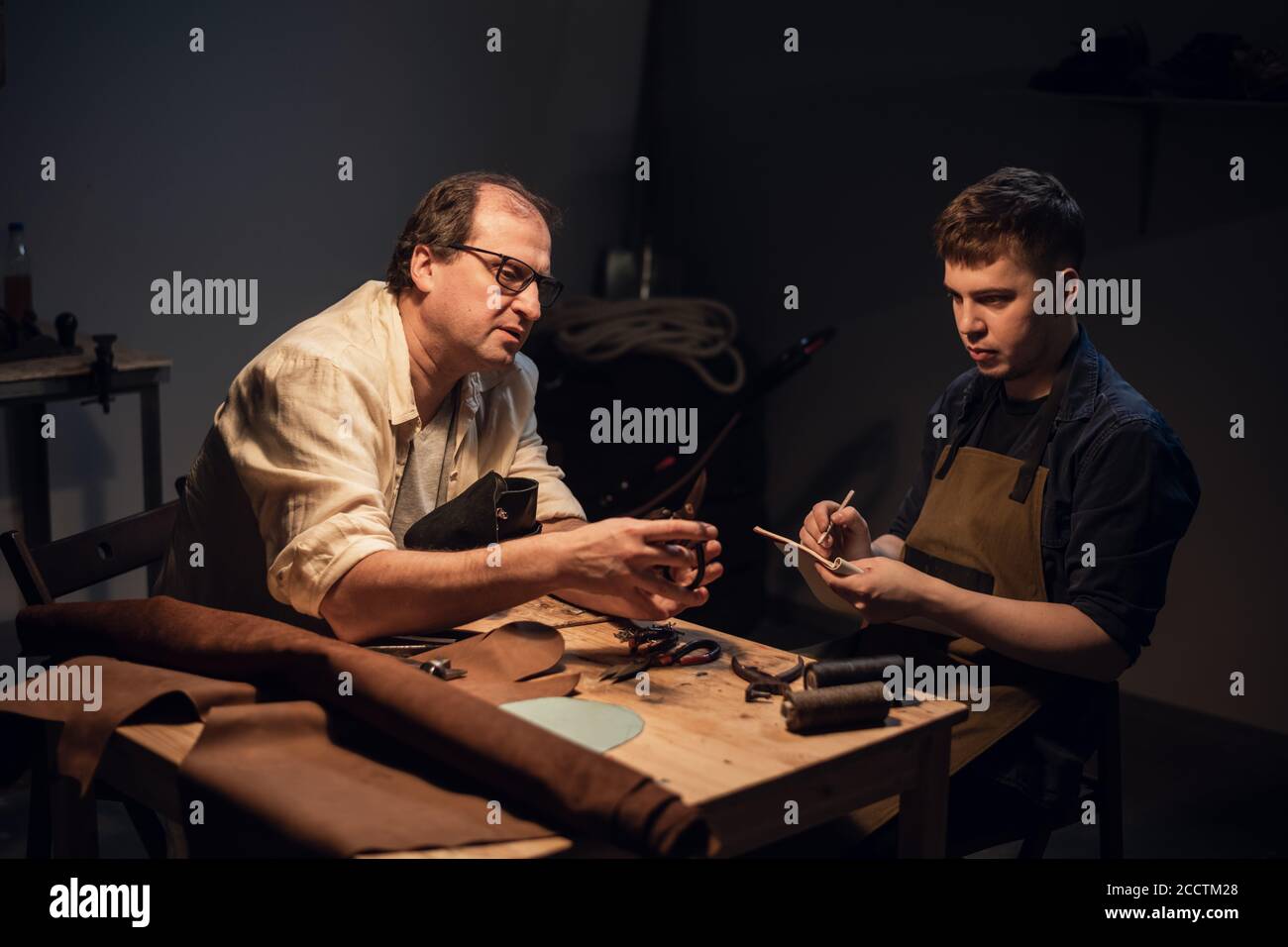 a respectable elderly shoemaker conducts a master class for a young boy ...