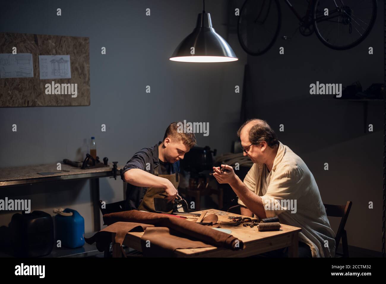 a respectable elderly shoemaker conducts a master class for a young boy ...