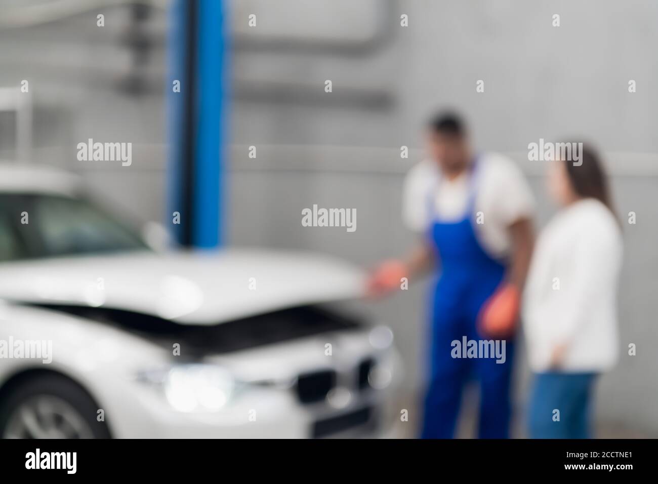 Mechanic show customer engine. Car hood open. Longshot Stock Photo - Alamy