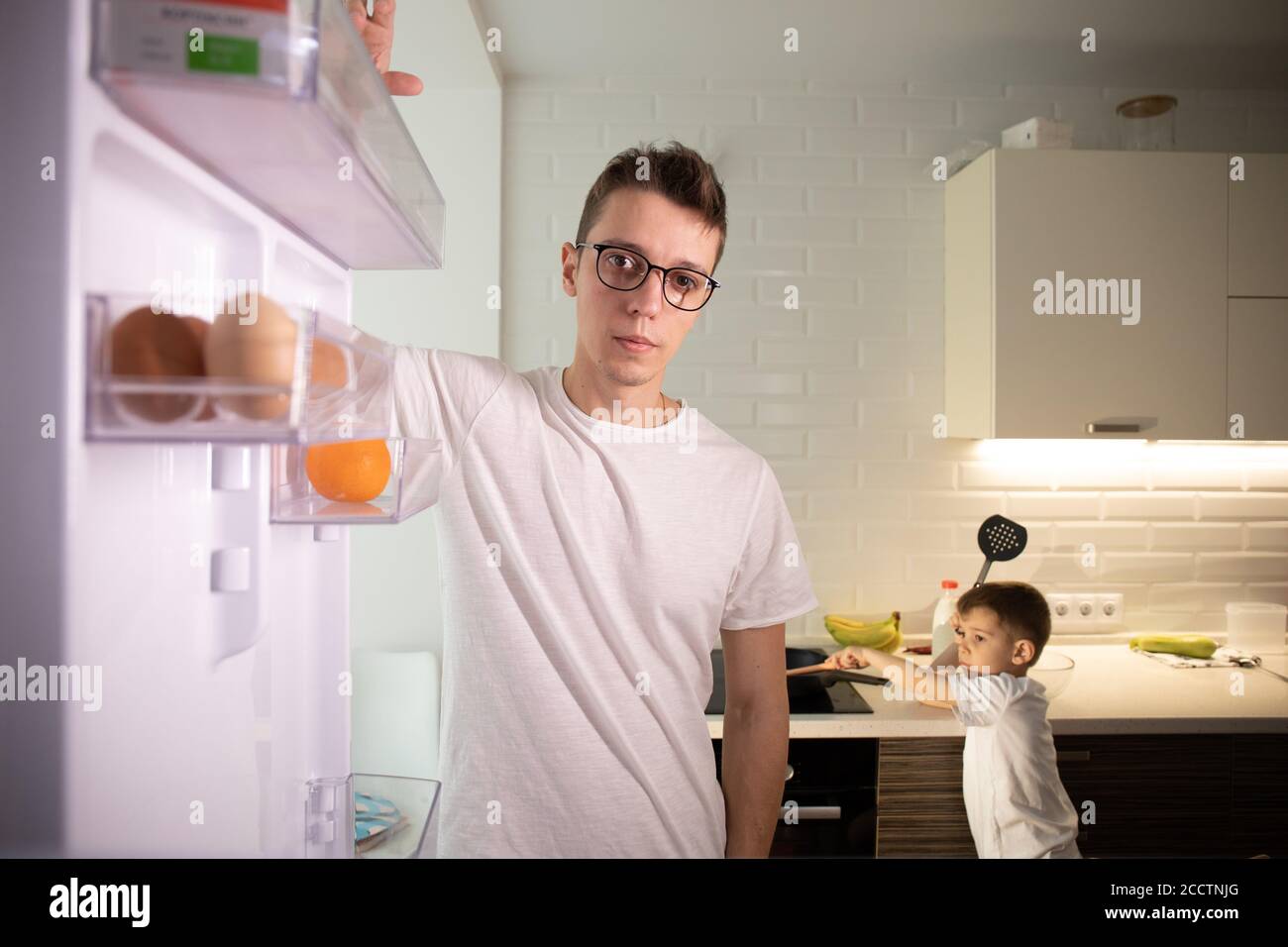 Camera Inside Kitchen Fridge: Man Opens Fridge Door, Looks inside Stock ...