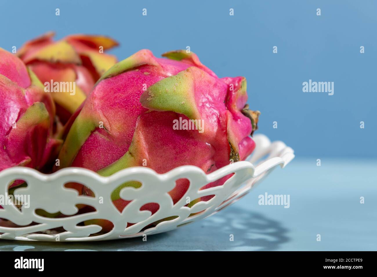 Pitaya fruits. Dragon fruit. Blue background. Pitaya is a natural fruit ...