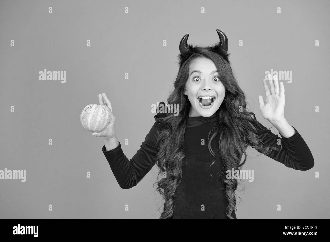 Evil demon. Little demon of child orange background. Happy girl with ...