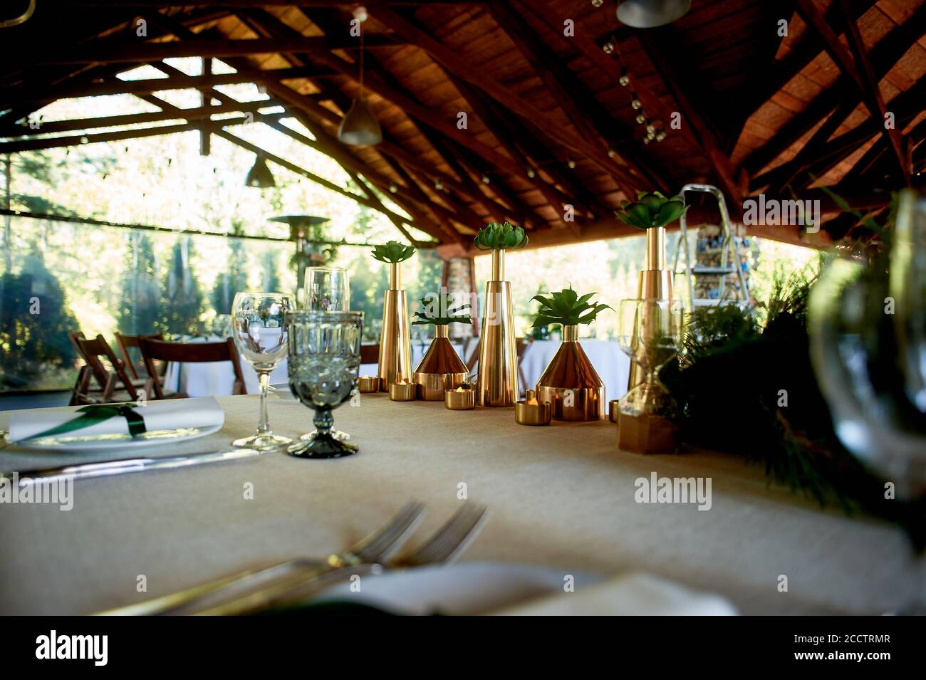 Banquet hall in the open air with a wooden ceiling, hanging garlands ...