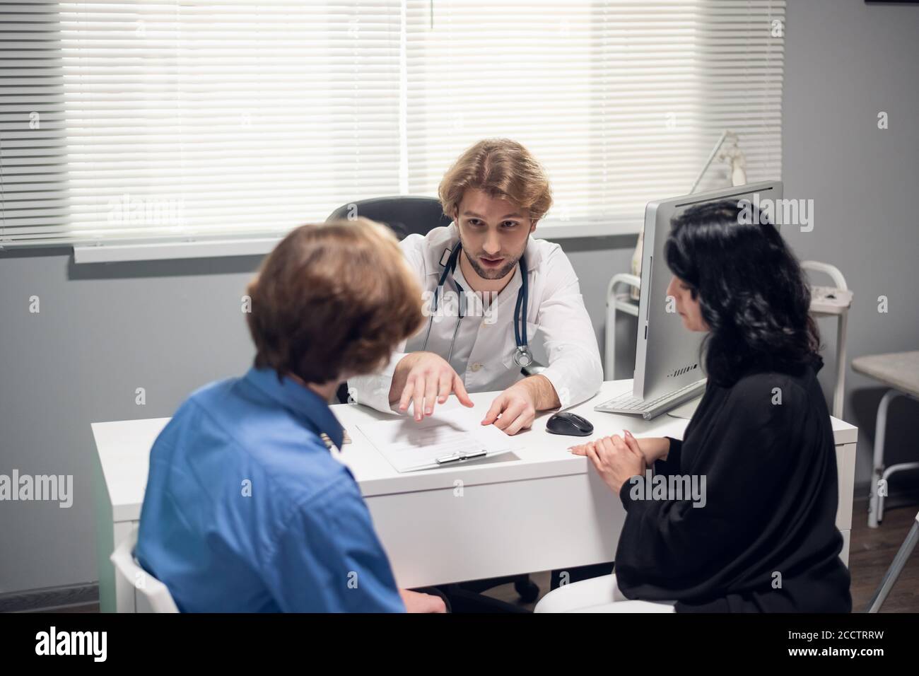 A family at the doctors appointment, having an annual medical checkup ...