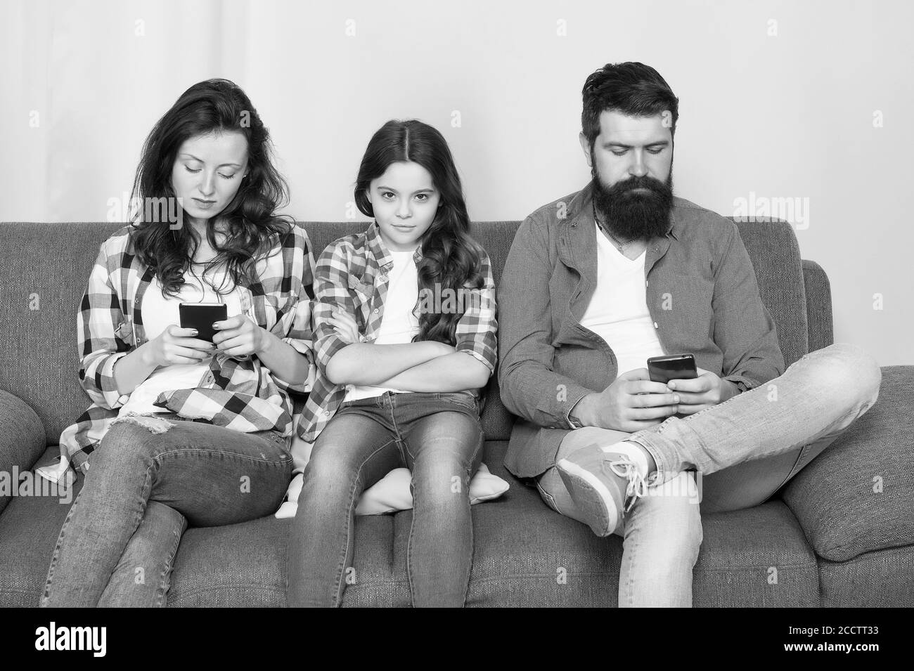Technology distracting family from child. Small child and parents ...