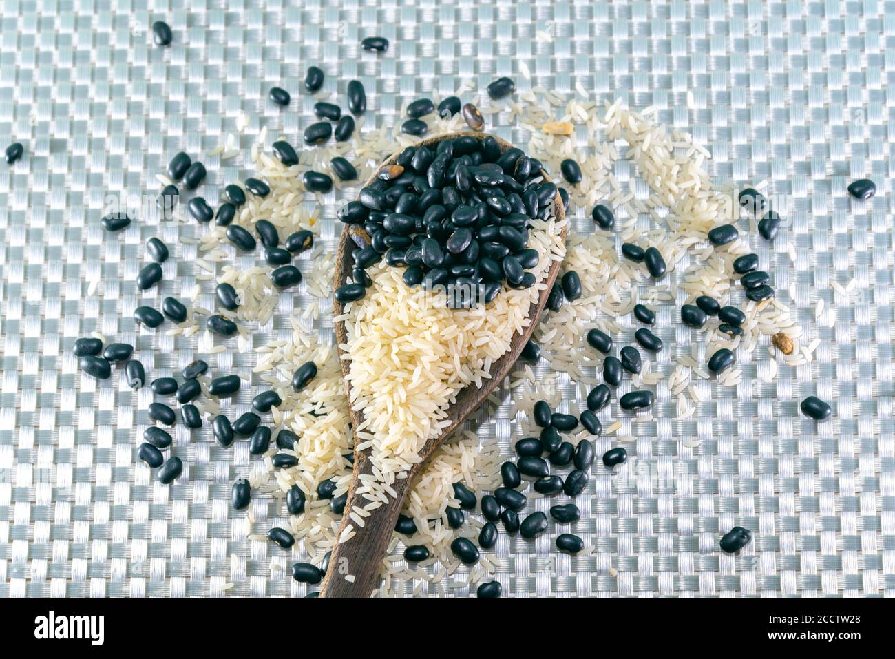 Grains of rice and beans in natura. Mixed grains arranged on a wooden ...