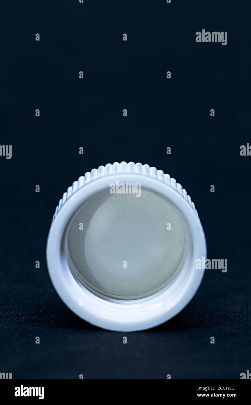 Plastic white cap on black background. Manufactured object Stock Photo ...