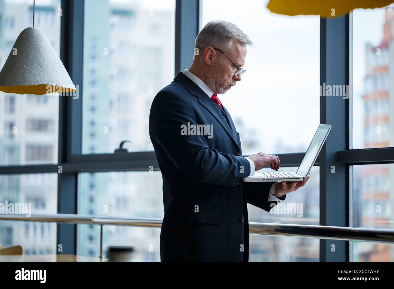 Smiling happy managing director thinks about his successful career ...