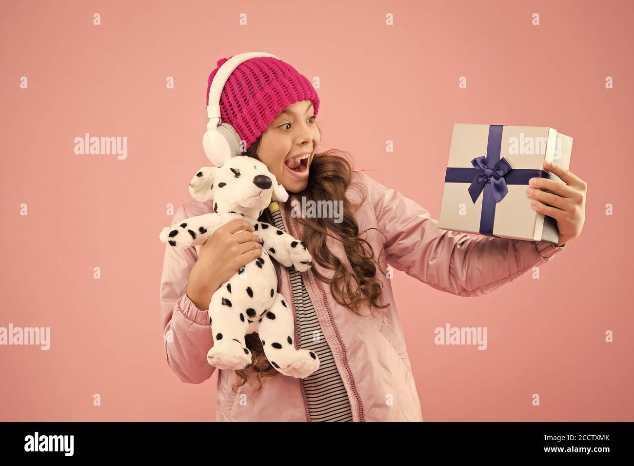 Surprise inside the box. Surprised child hold gift box pink background ...