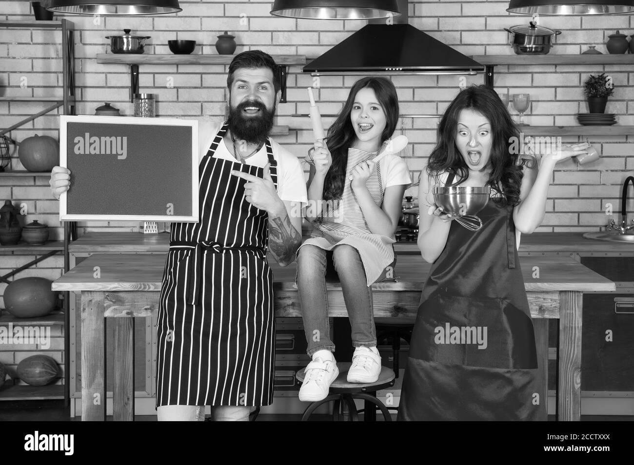 Mother and father teaching daughter how to cook. small girl with mom ...
