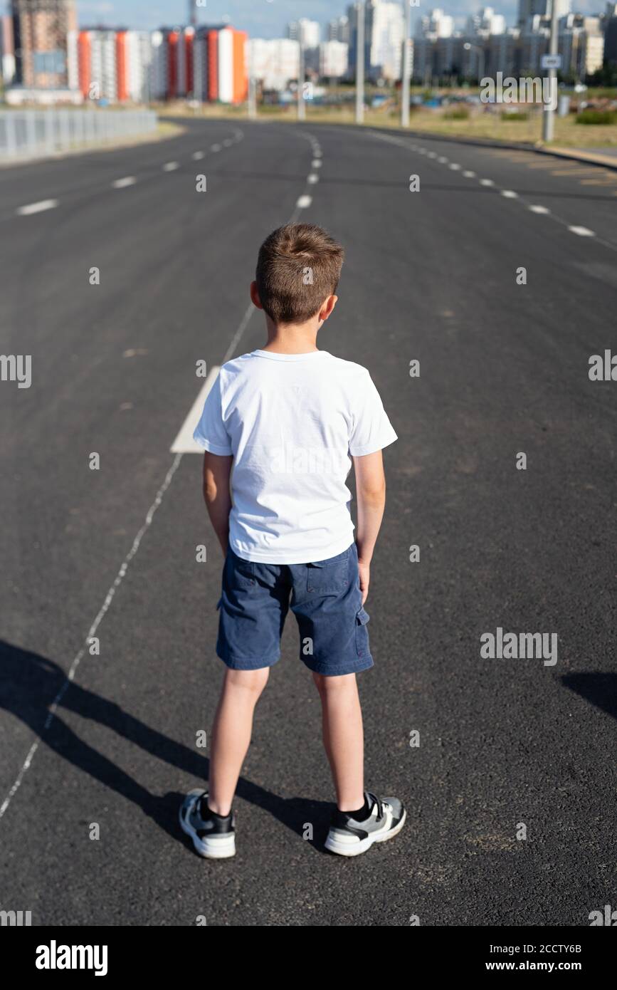 boy is standing on road, safety of children on the roadway, traffic ...