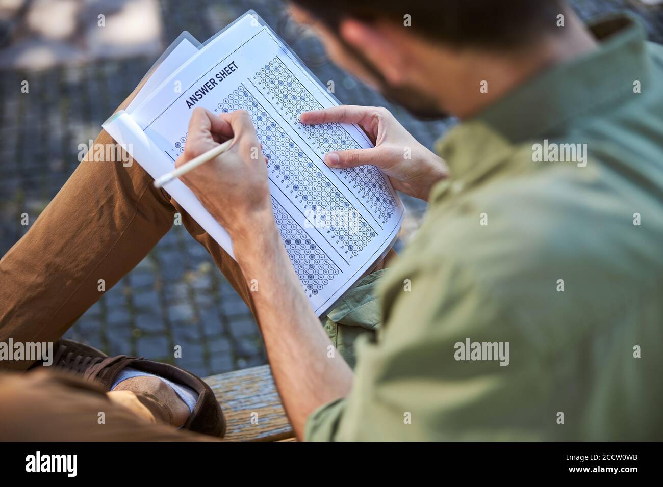 Young man studying for a multiple choice examination Stock Photo - Alamy