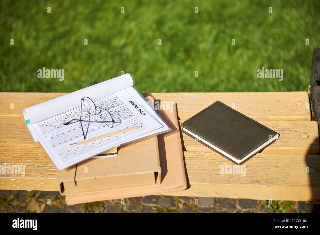 Items on the bench essential for an exam preparation Stock Photo - Alamy