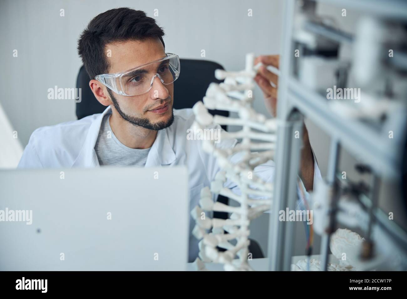 Medical student examining the 3D printed DNA model Stock Photo - Alamy