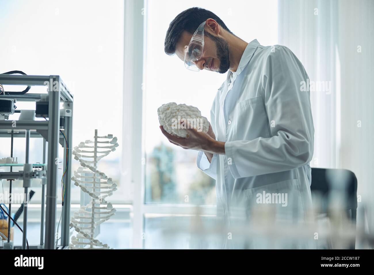 Man in safety goggles working in a research laboratory Stock Photo - Alamy