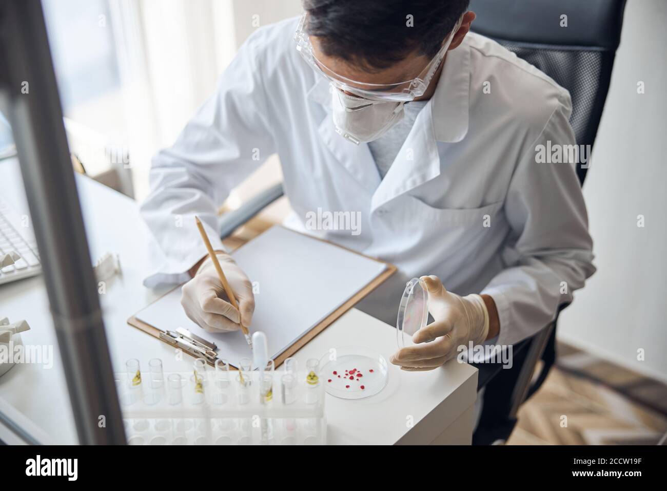 Male scientist working in a virology laboratory Stock Photo - Alamy