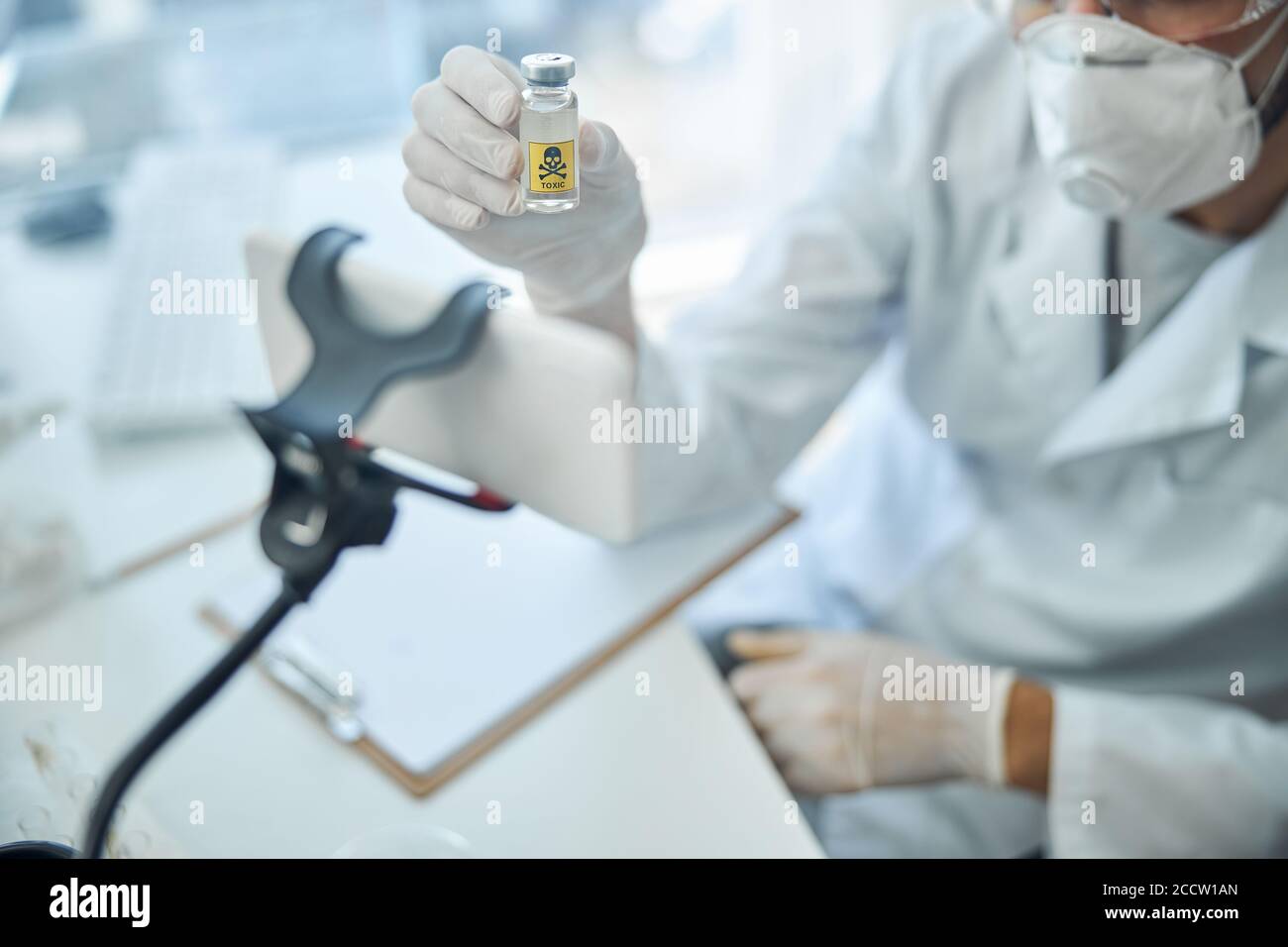 Male scientist demonstrating a glass vial with hazardous material Stock ...