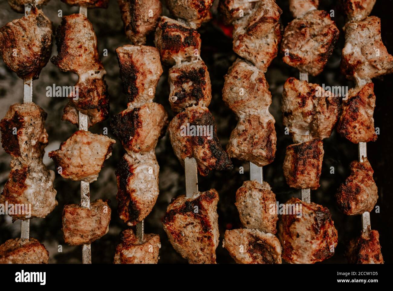 Pork veal cow meat cut into square pieces and fried over a fire Stock ...
