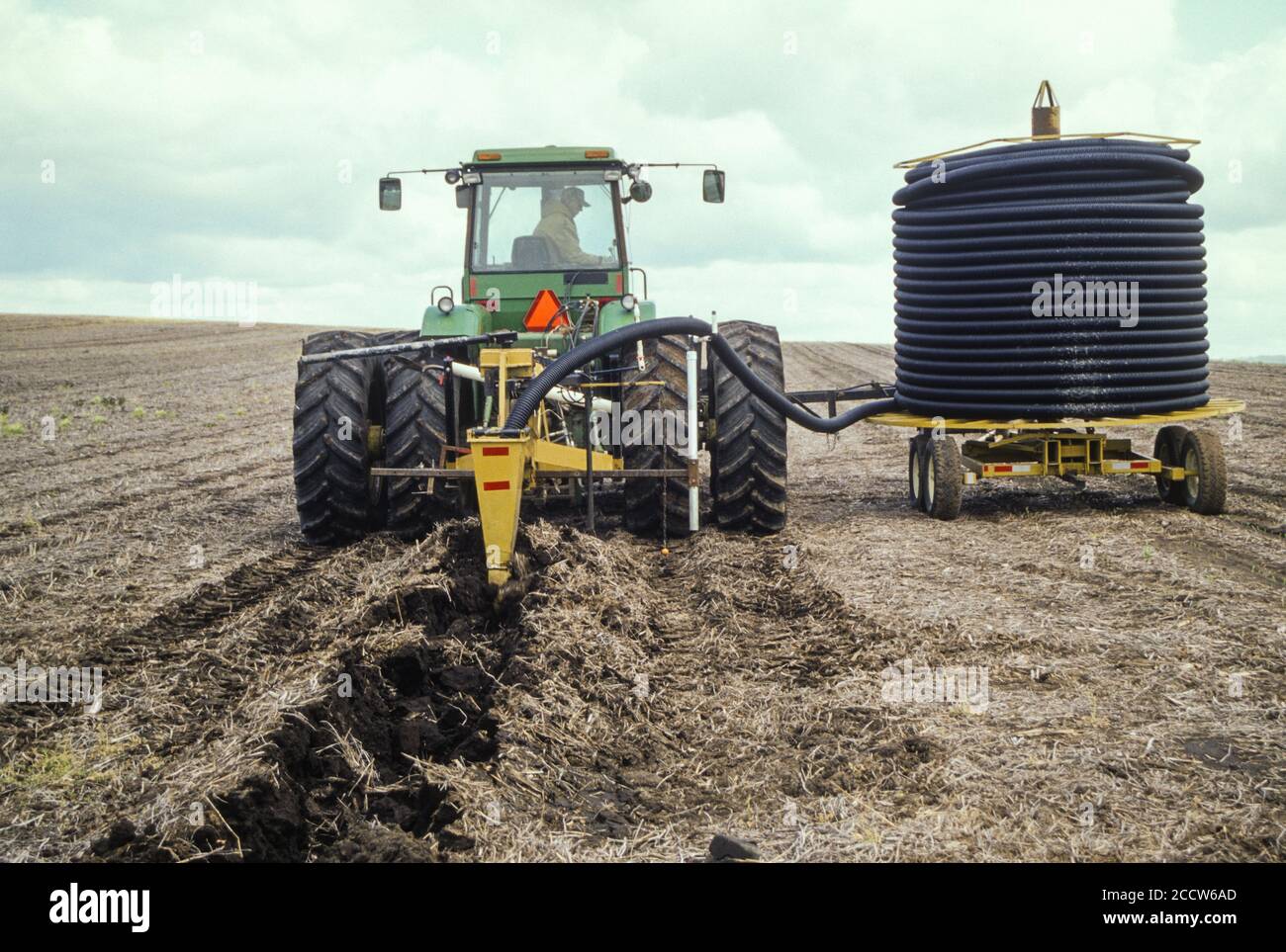 Laying Drainage Tile in a farmer's Field. Reducing Moisture content of ...