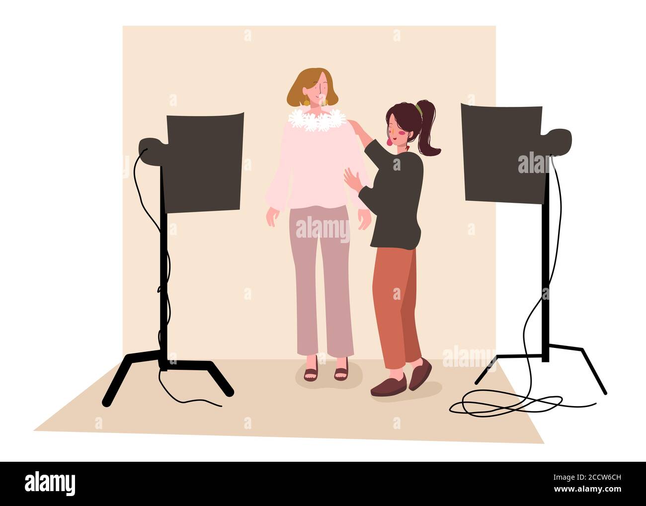 Model is being dressed by stylist during photo session break in studio ...