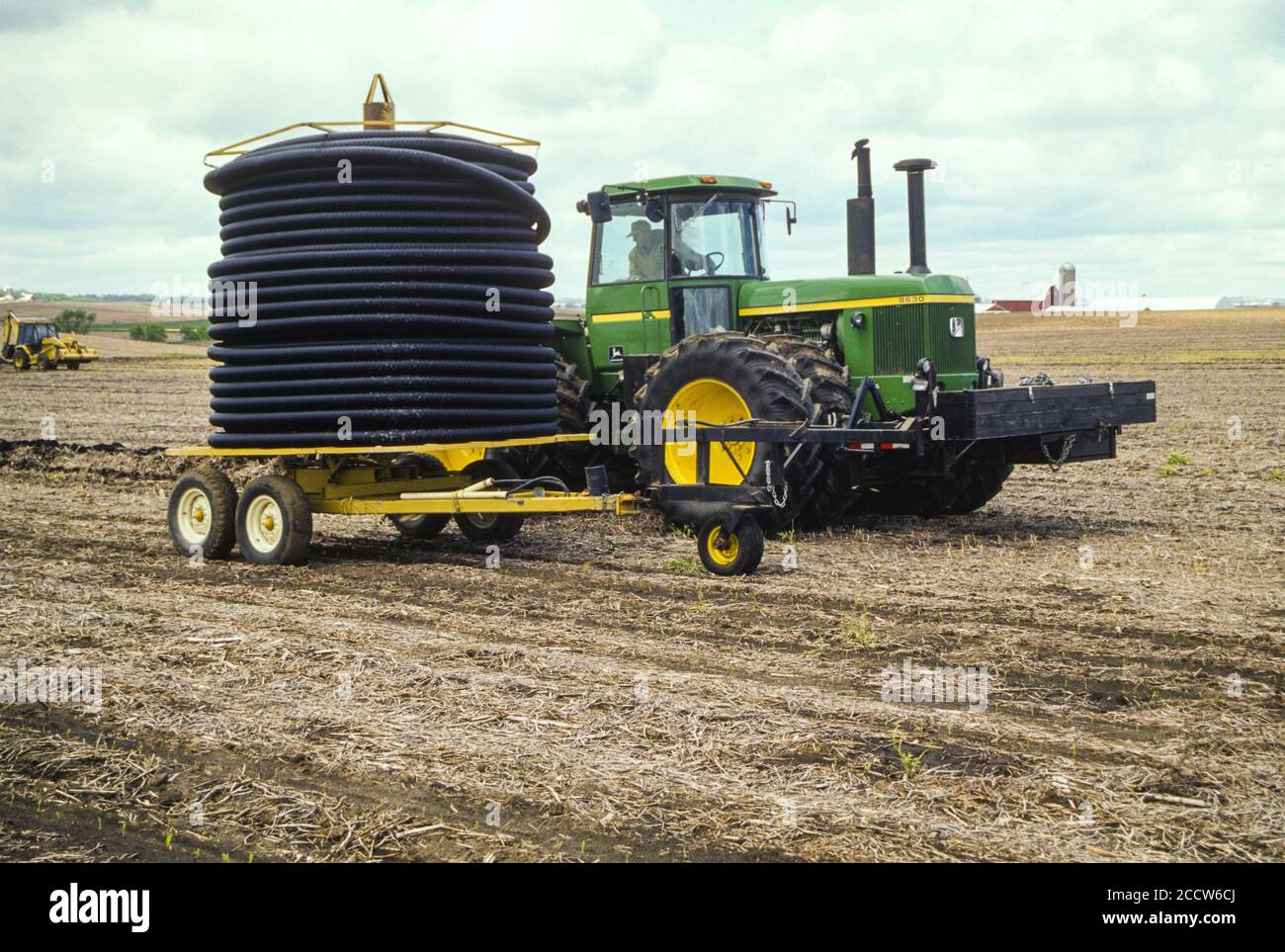 Laying Drainage Tile in a farmer's Field. Reducing Moisture content of ...