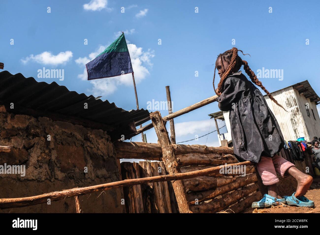 Nairobi, Kenya. 20th Aug, 2020. A young girl stands by the street walls ...