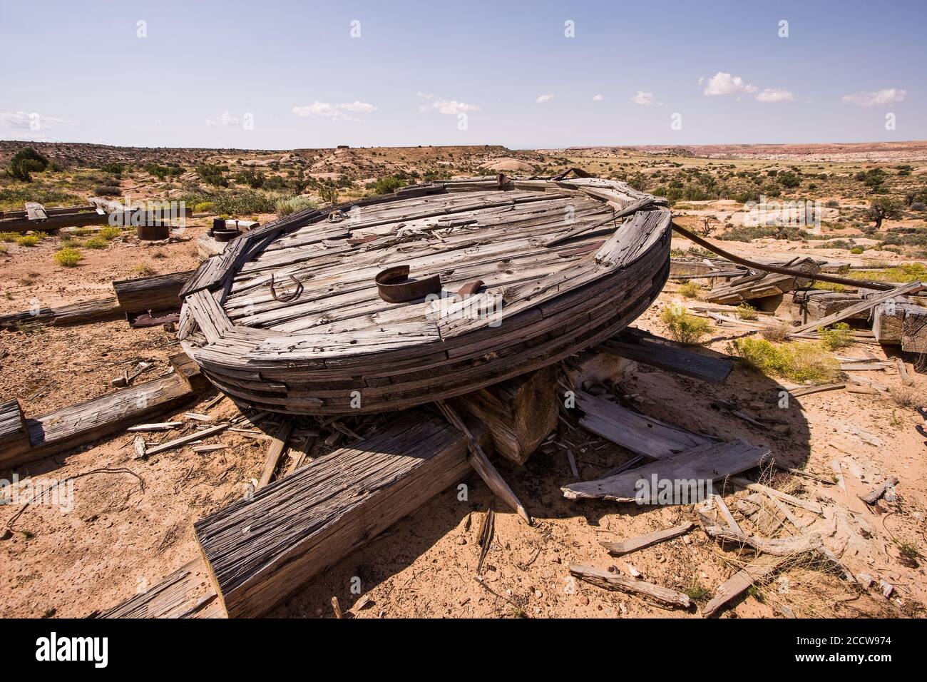 Large wooden bull wheel or band wheel in the wreckage of a 1920's era ...