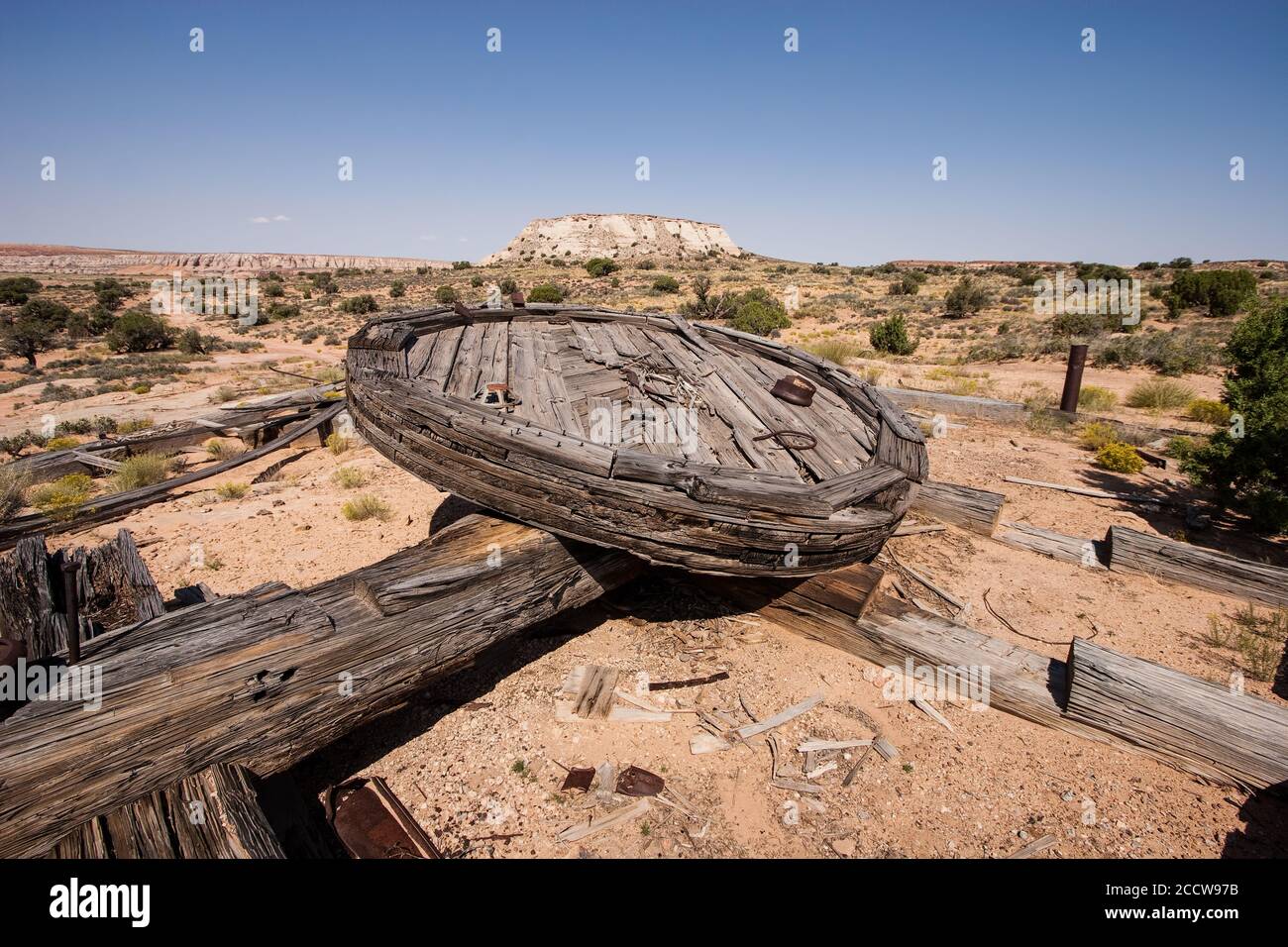 Large wooden bull wheel or band wheel in the wreckage of a 1920's era ...