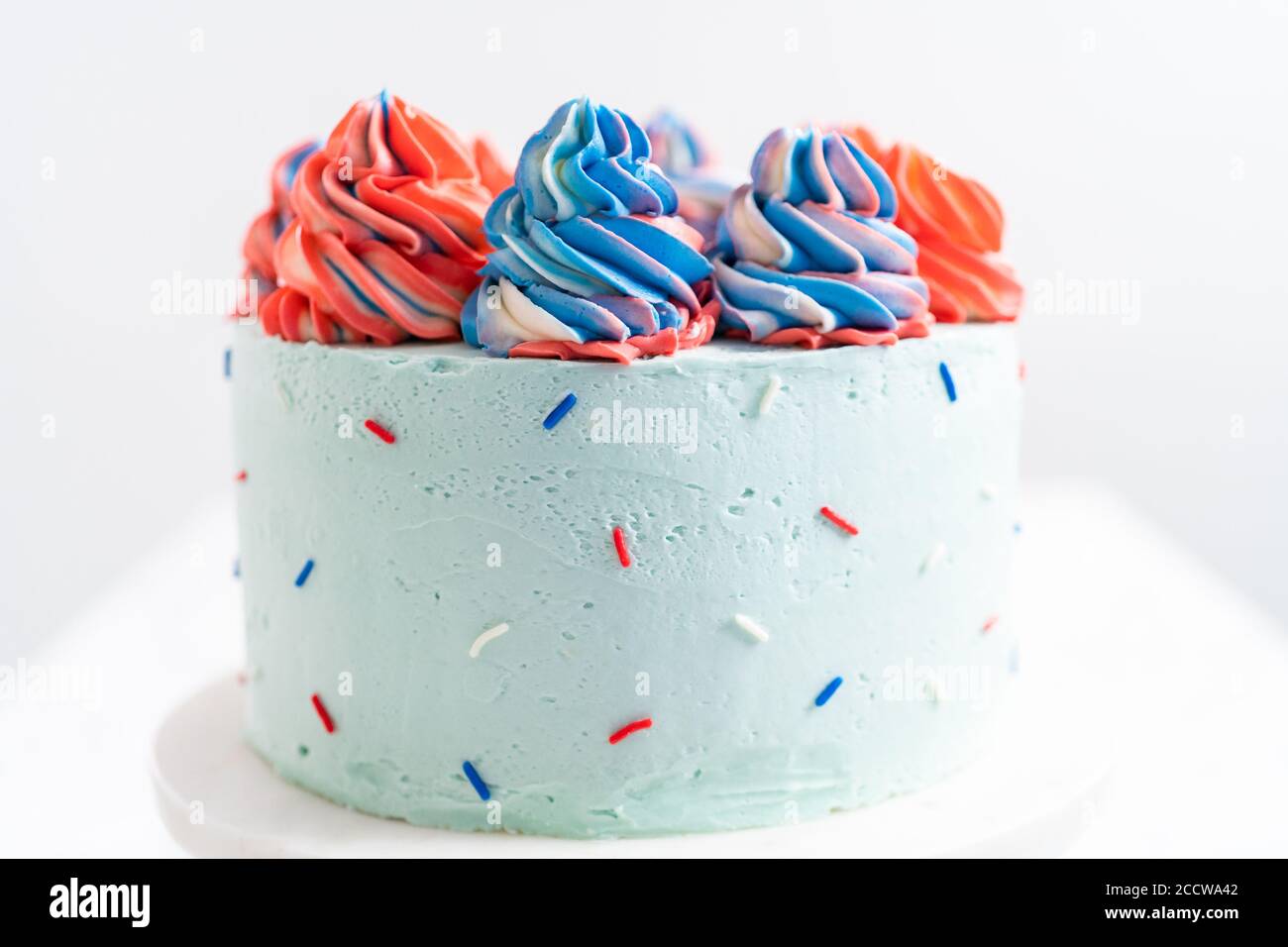 Red, white, and blue round vanilla cake with buttercream frosting for ...