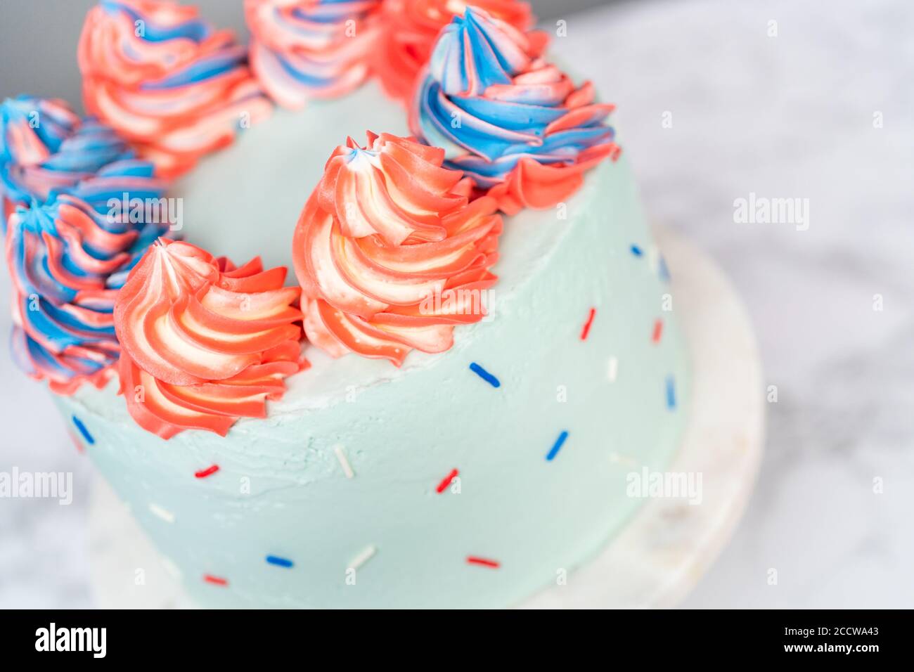 Red, white, and blue round vanilla cake with buttercream frosting for ...