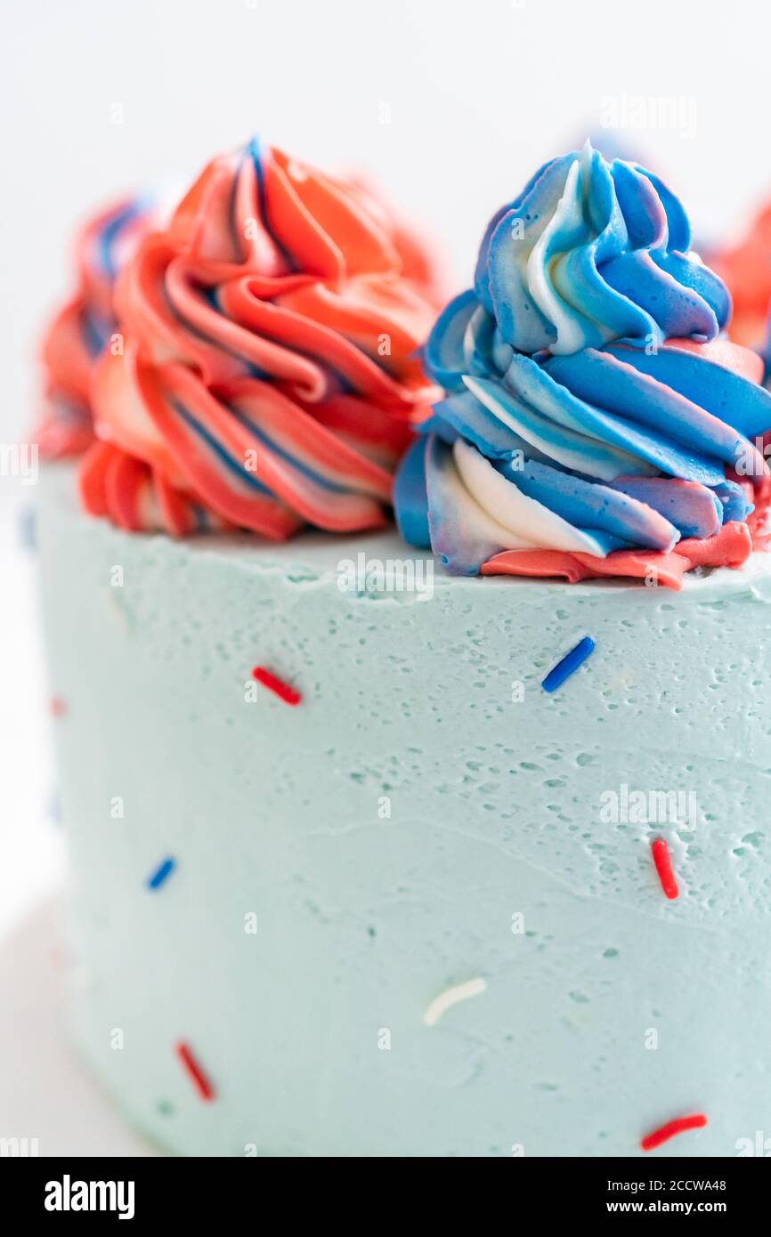 Red, white, and blue round vanilla cake with buttercream frosting for ...