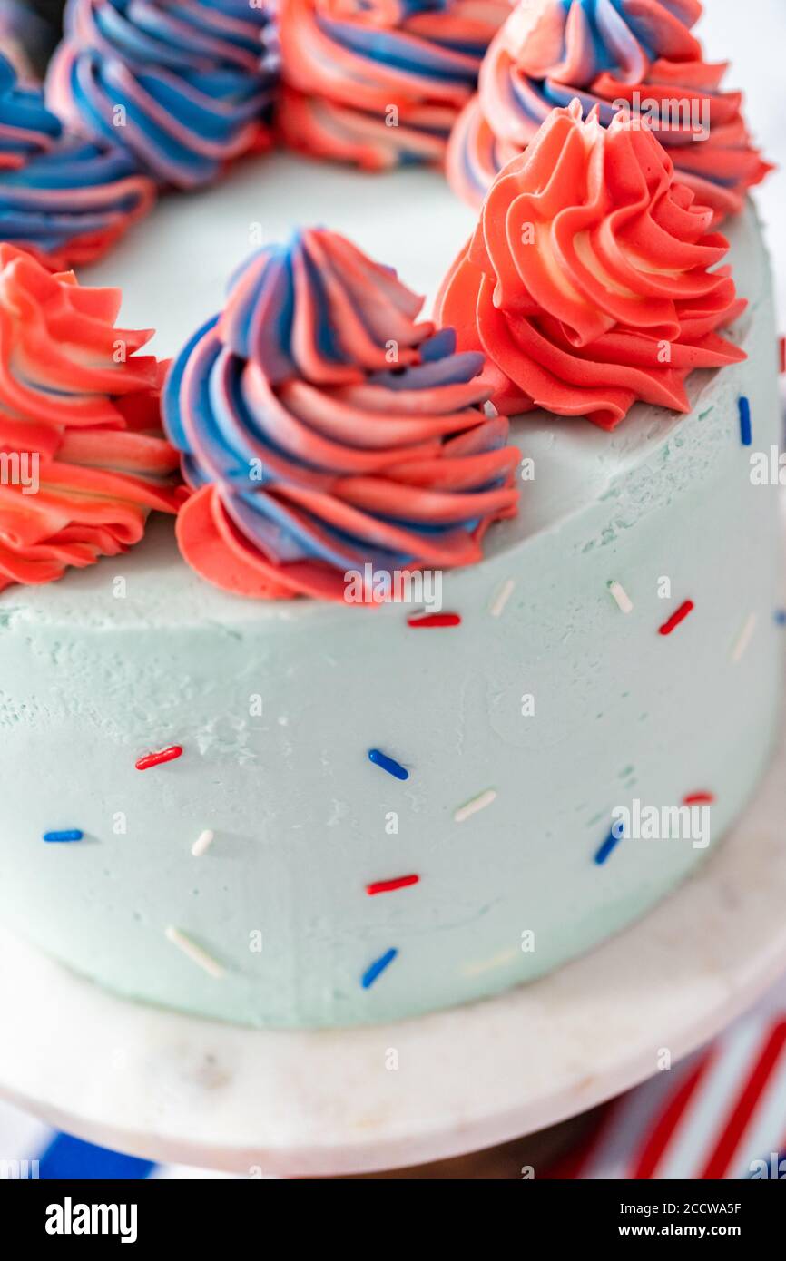 Red, white, and blue round vanilla cake with buttercream frosting for ...