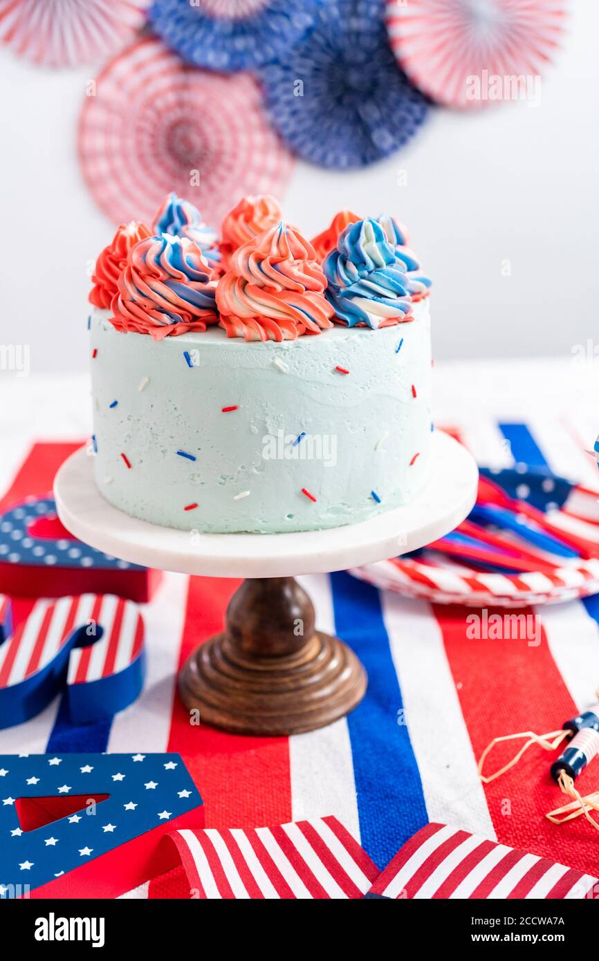 Red, white, and blue round vanilla cake with buttercream frosting for ...
